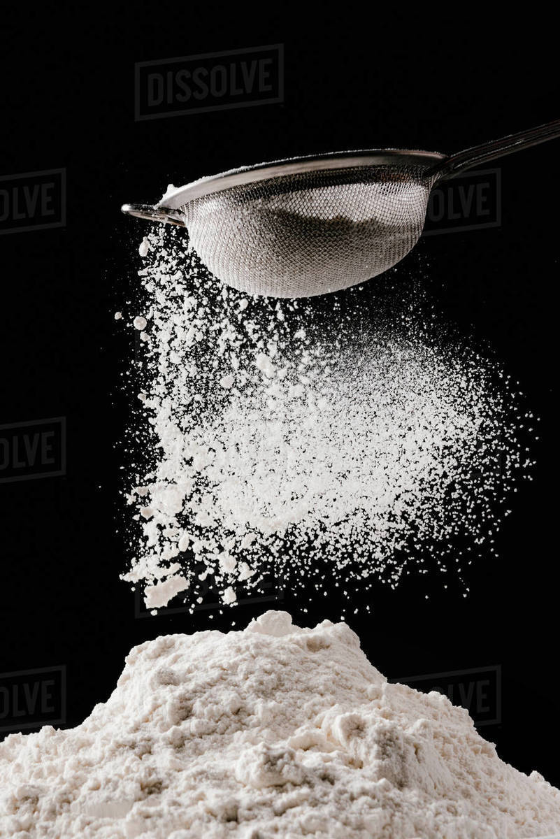 Flour falling from sieve on pile isolated on black - Royalty-free Stock ...