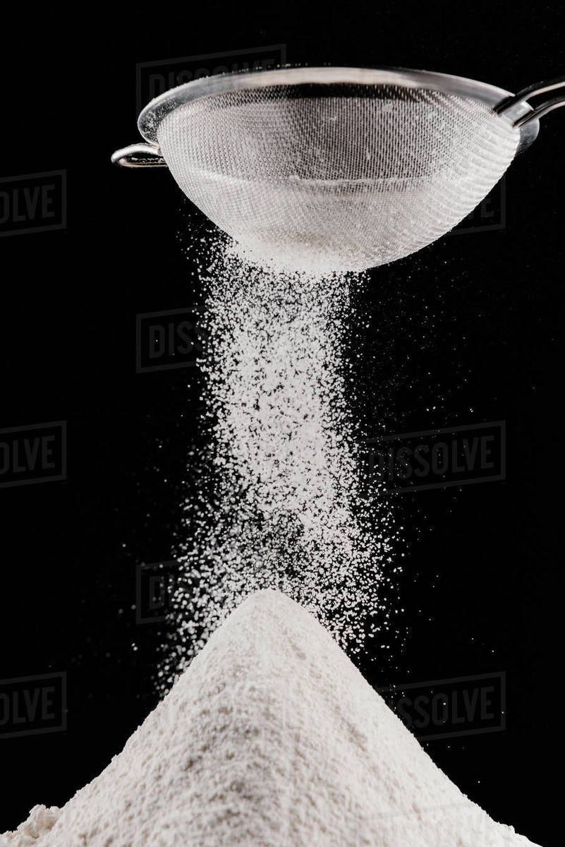 Flour falling from sieve on pile isolated on black - Royalty-free Stock ...