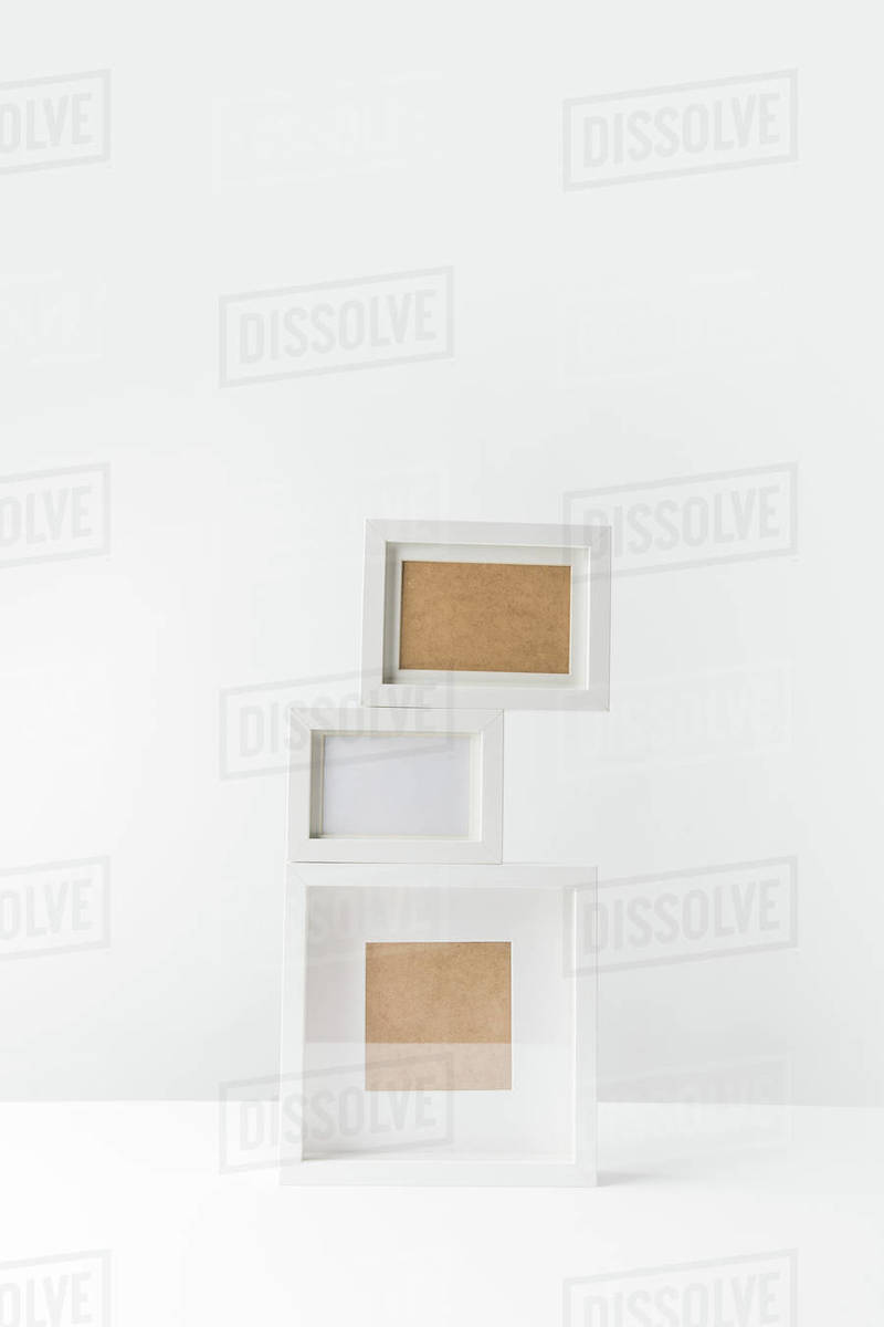 Empty white photo frames stacked on white - Stock Photo - Dissolve