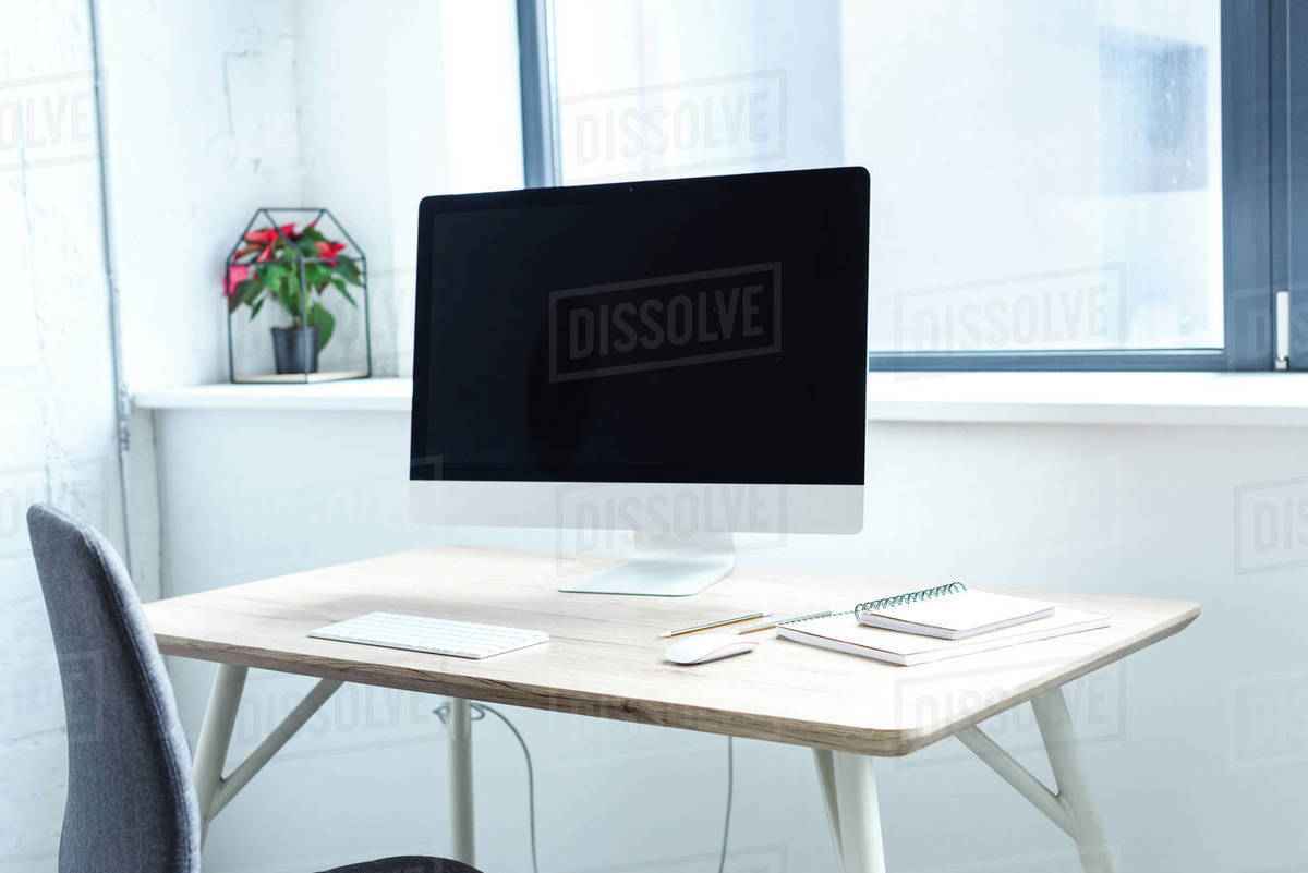 Blank screen of computer on working table - Stock Photo - Dissolve