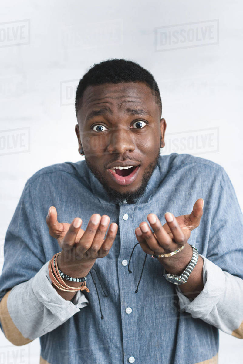 Surprised African American man by white wall - Royalty-free Stock Photo ...