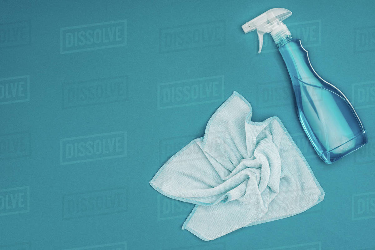 Top view of blue rag and spray bottle isolated on blue - Royalty-free ...