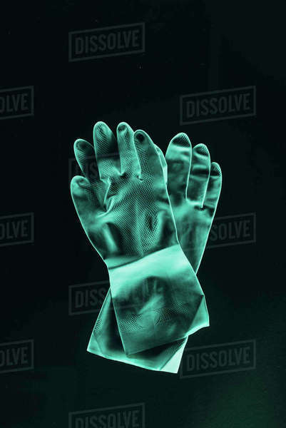 Top view of protective rubber turquoise gloves isolated on black ...
