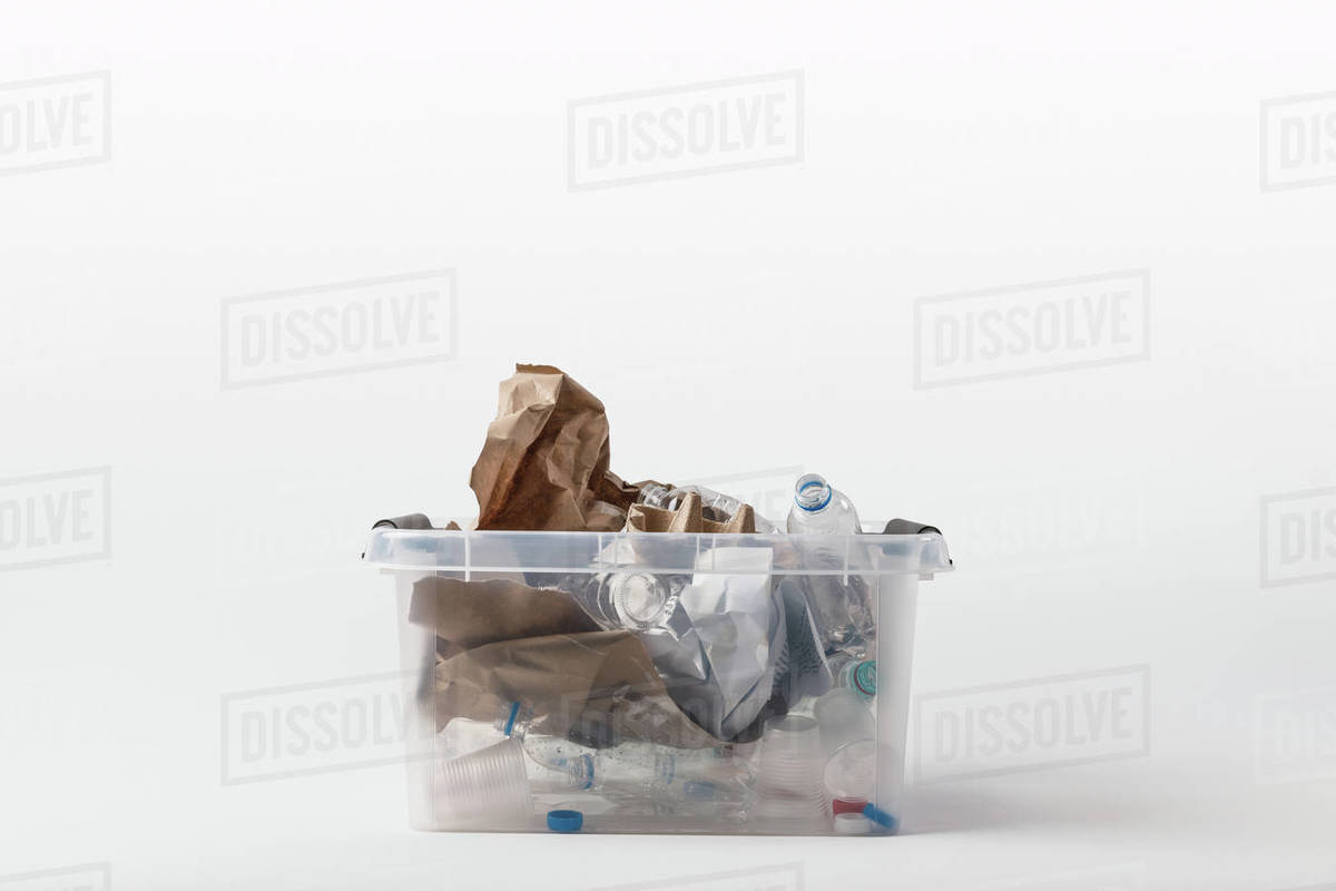 Close up view of container with paper and plastic garbage isolated on ...