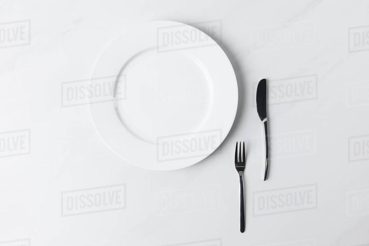 Top view of plate with fork and knife, table appointments conception ...