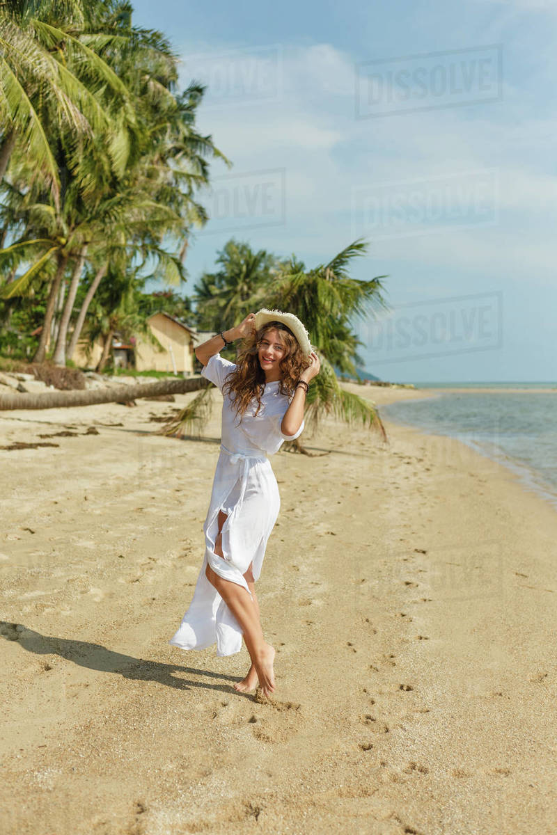 Happy slim girl walking on tropical beach at the ocean - Royalty-free ...