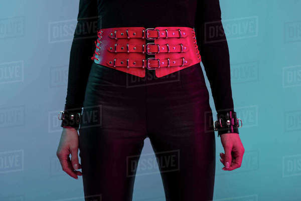 Attractive hot girl wearing wide red belt isolated on blue - Royalty ...