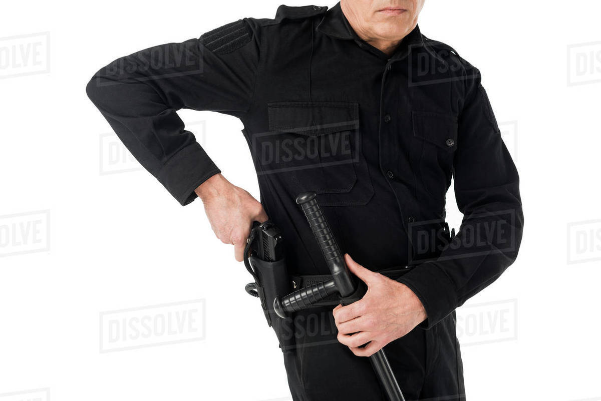 Close-up view of policeman in uniform pulling out gun isolated on white ...