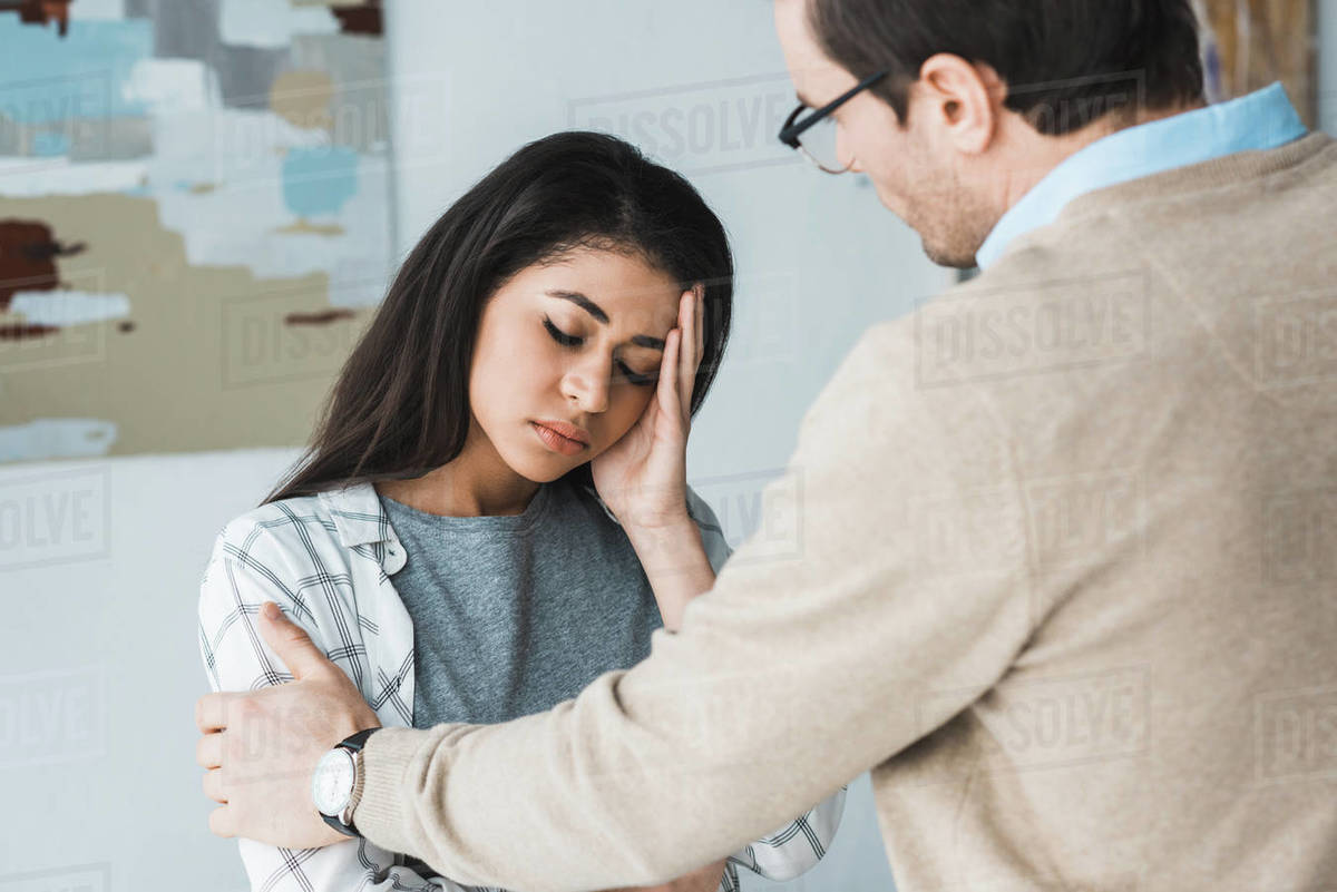 Therapist supporting his upset female patient - Royalty-free Stock ...