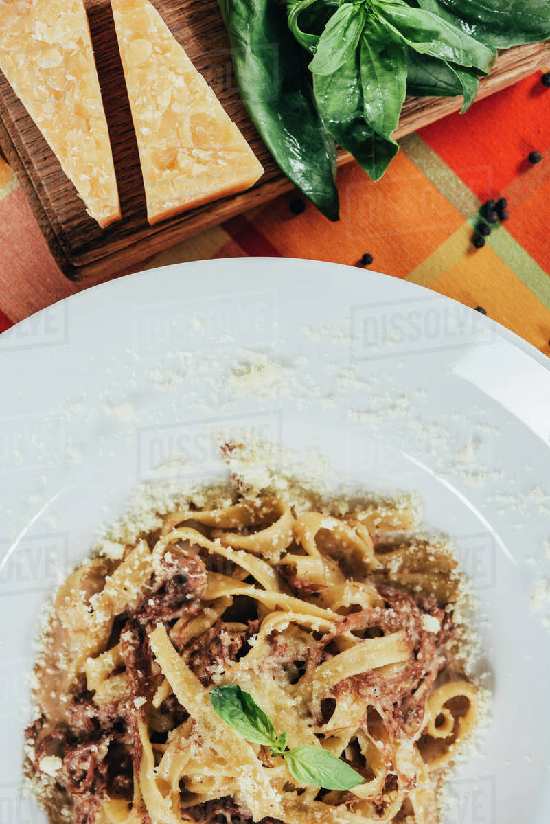 Top view of pasta with meat and parmesan cheese on plate - Royalty-free ...