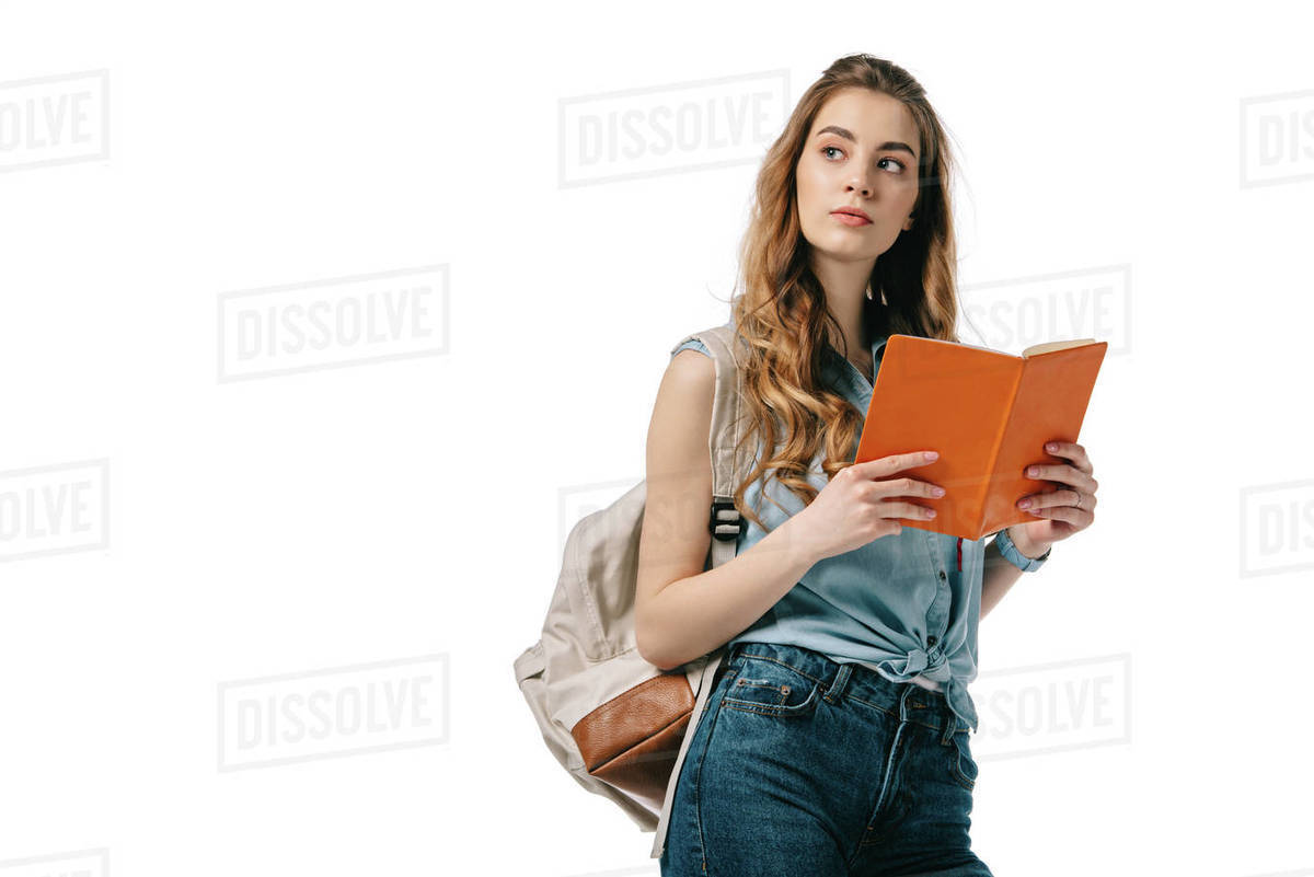 Beautiful student holding open book and looking away isolated on white ...