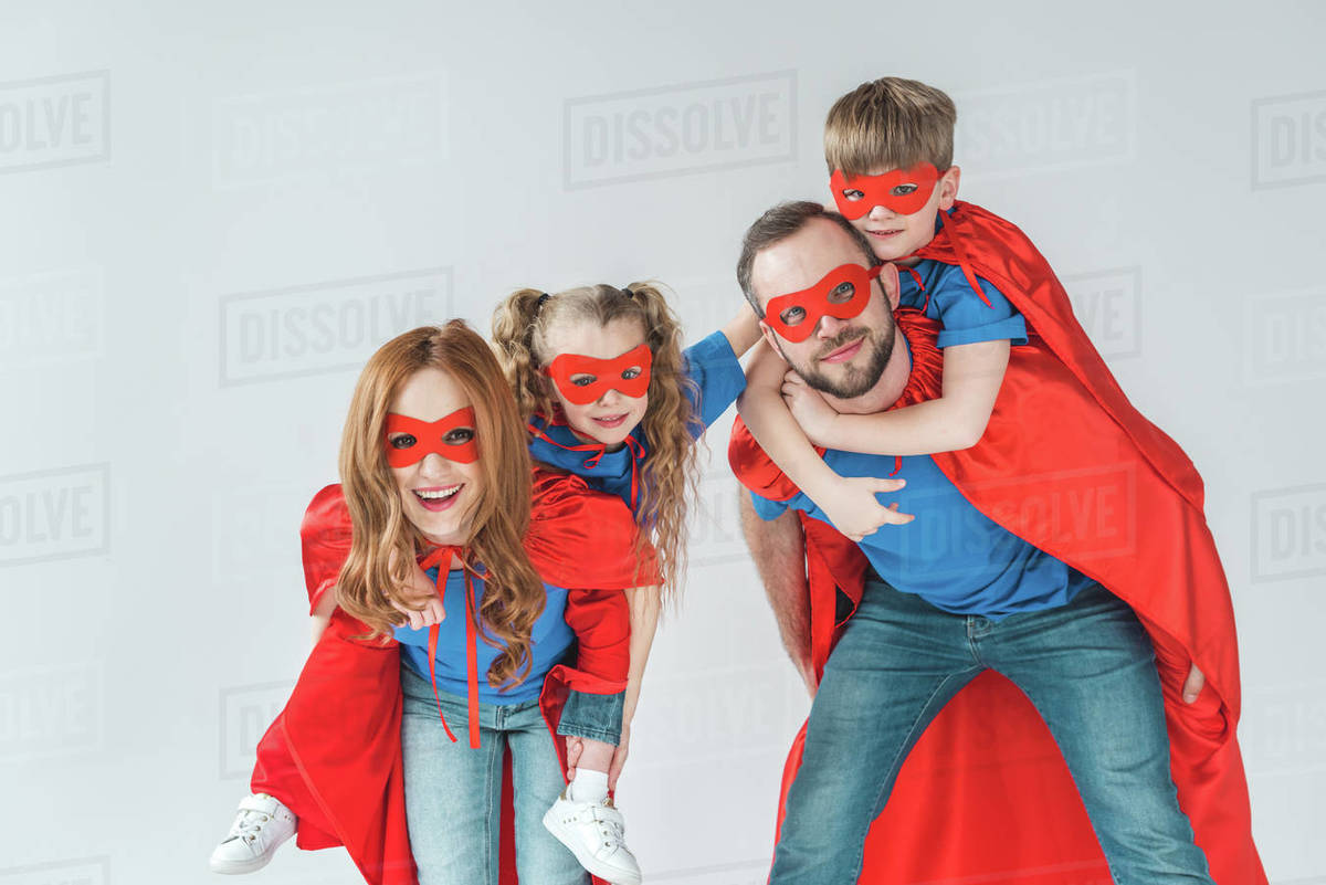 Super parents piggybacking kids pretending to be superheroes isolated ...
