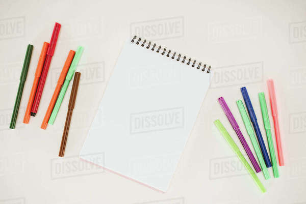 Top view of blank notepad with colorful markers isolated on white ...