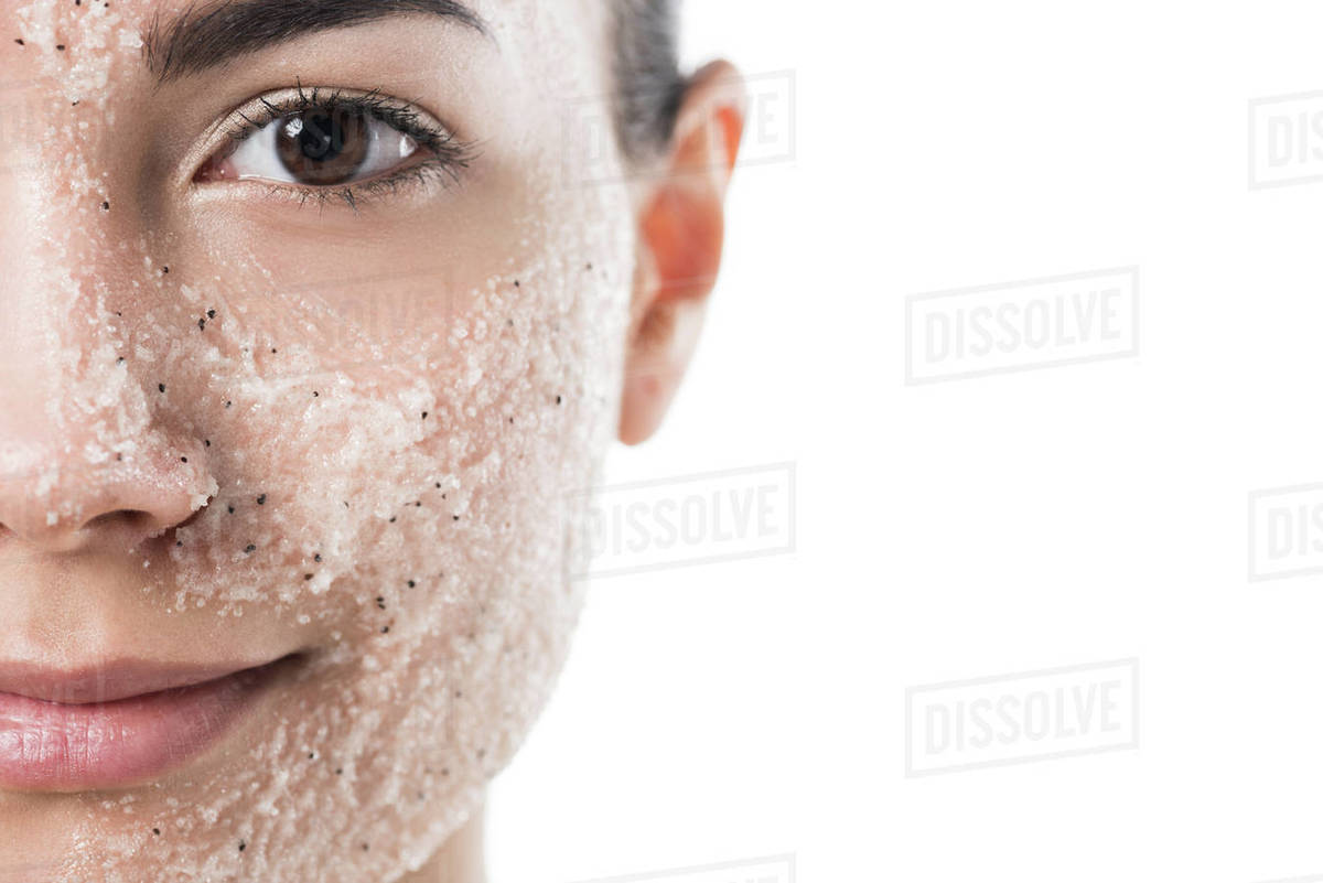 Cropped image of beautiful girl with facial scrub looking at camera ...