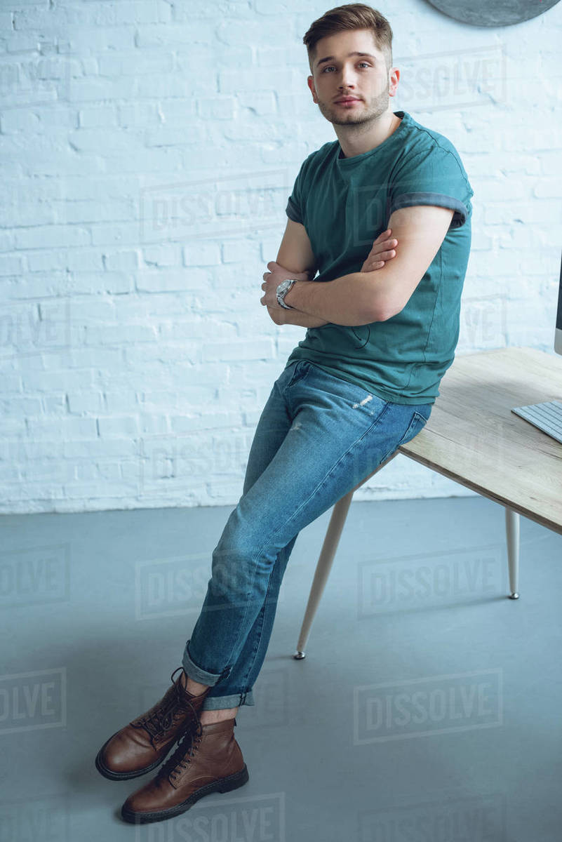 Stylish man in casual clothes leaning on table - Royalty-free Stock ...