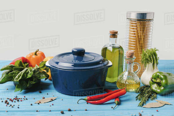 Ingredients for cooking pasta with vegetables and pan on table ...