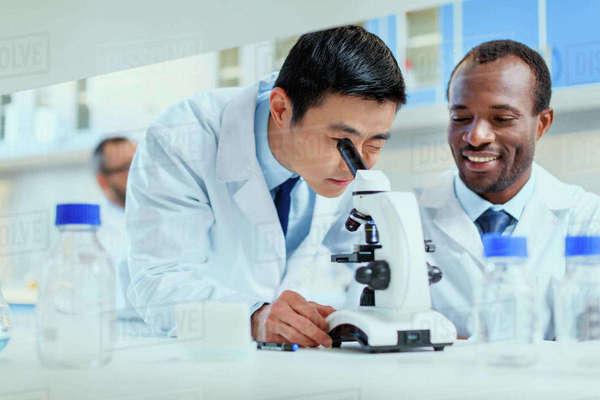 Young doctors in uniform working at testing laboratory, laboratory ...
