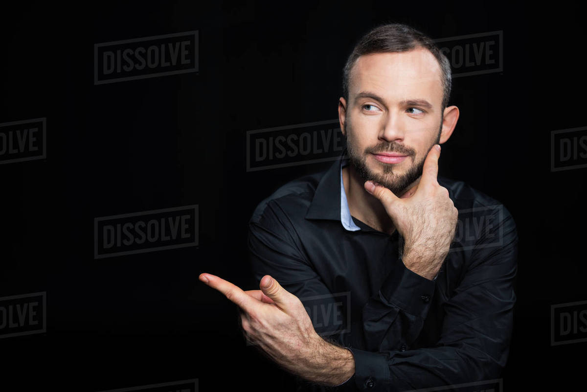 Bearded handsome man pointing with finger isolated on black - Royalty ...