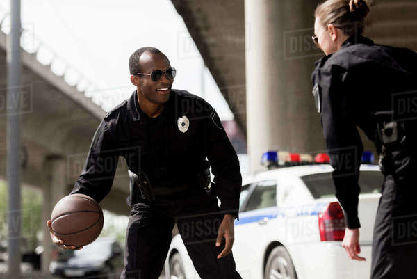 Young police officers playing basketball near car - Royalty-free Stock ...