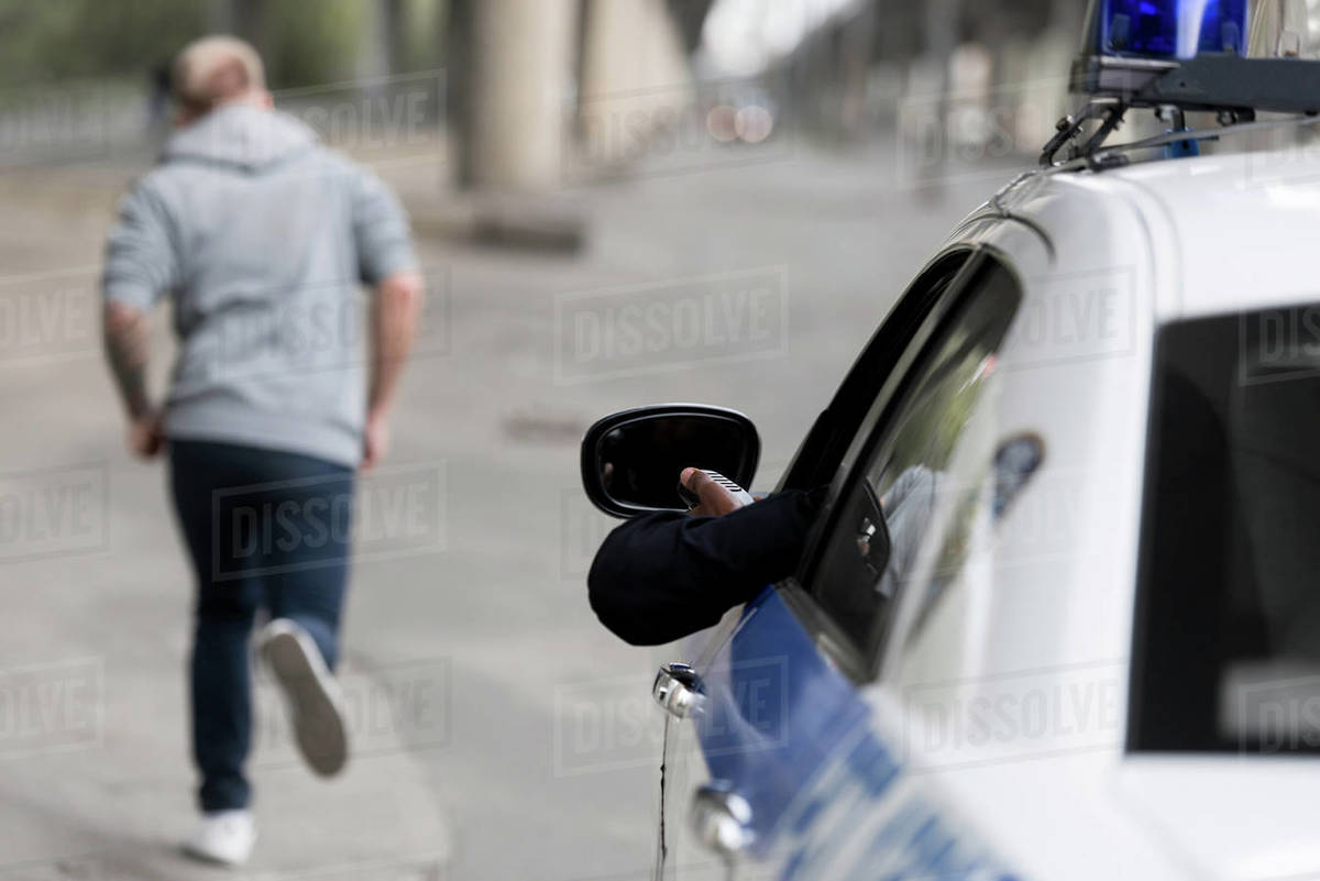 Cropped shot of policeman on car chasing thief - Royalty-free Stock ...