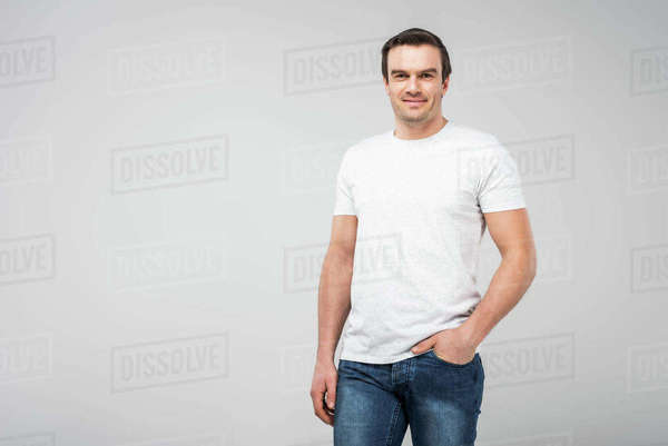 Smiling handsome man with hand in pocket, isolated on grey - Stock ...