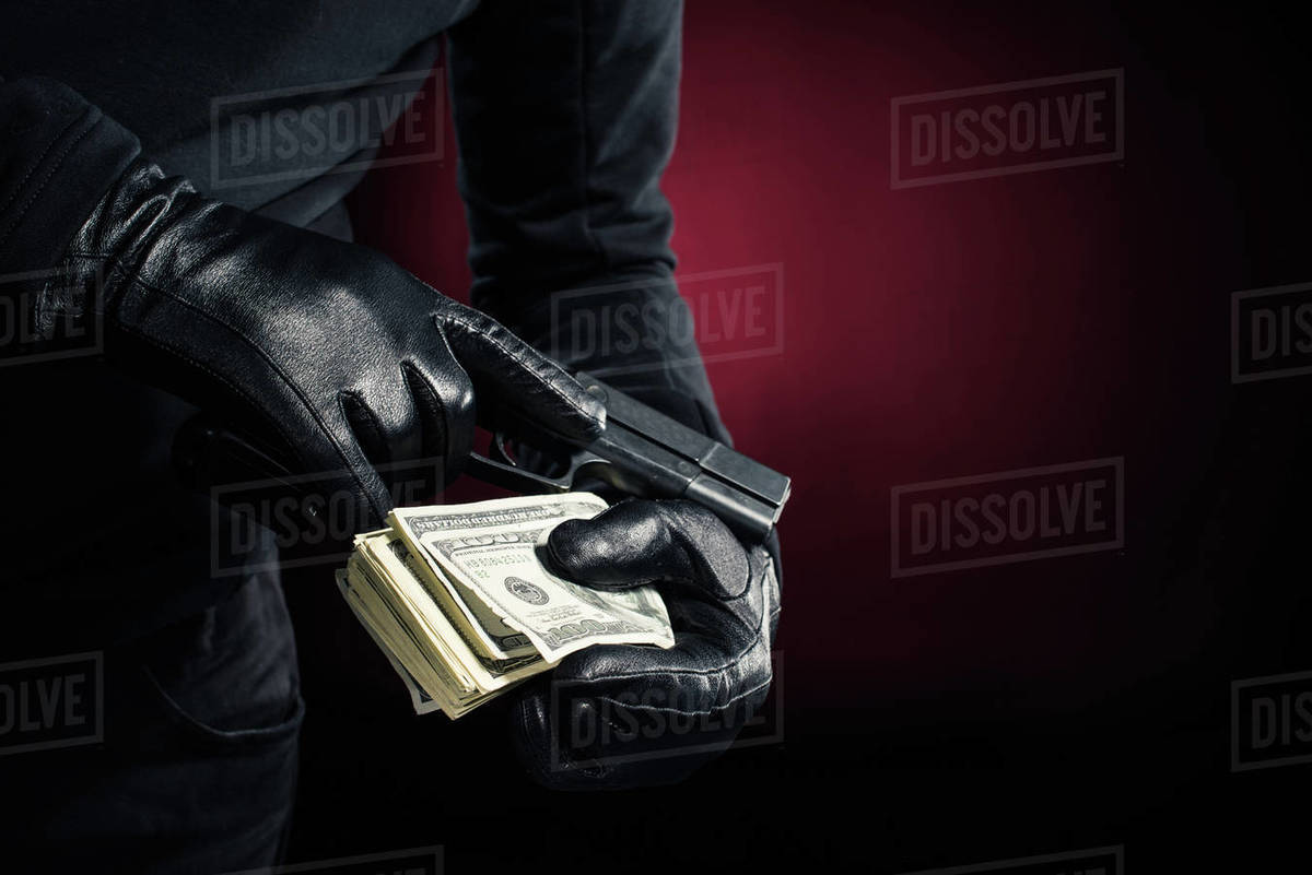 Cropped view of gun and dollars in hands of robber - Royalty-free Stock ...