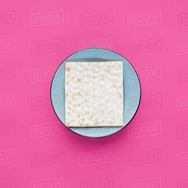 Top view of plate with matzah isolated on pink, Passover tale concept ...
