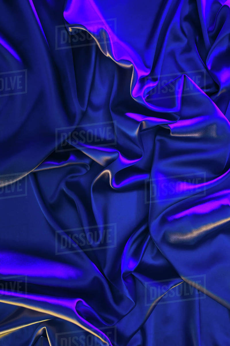 Ultra violet and blue shiny silk fabric background - Stock Photo - Dissolve