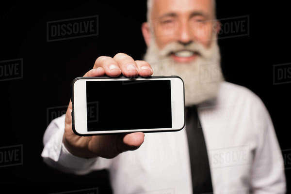 Closeup shot of man in a suit holding out a smartphone and showing ...