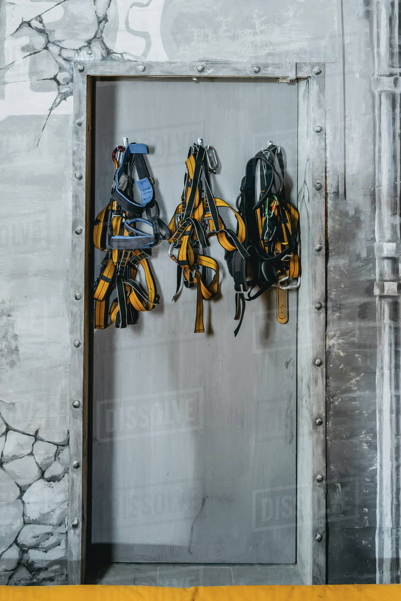 Climbing harnesses hanging on the wall at the gym - Royalty-free Stock ...