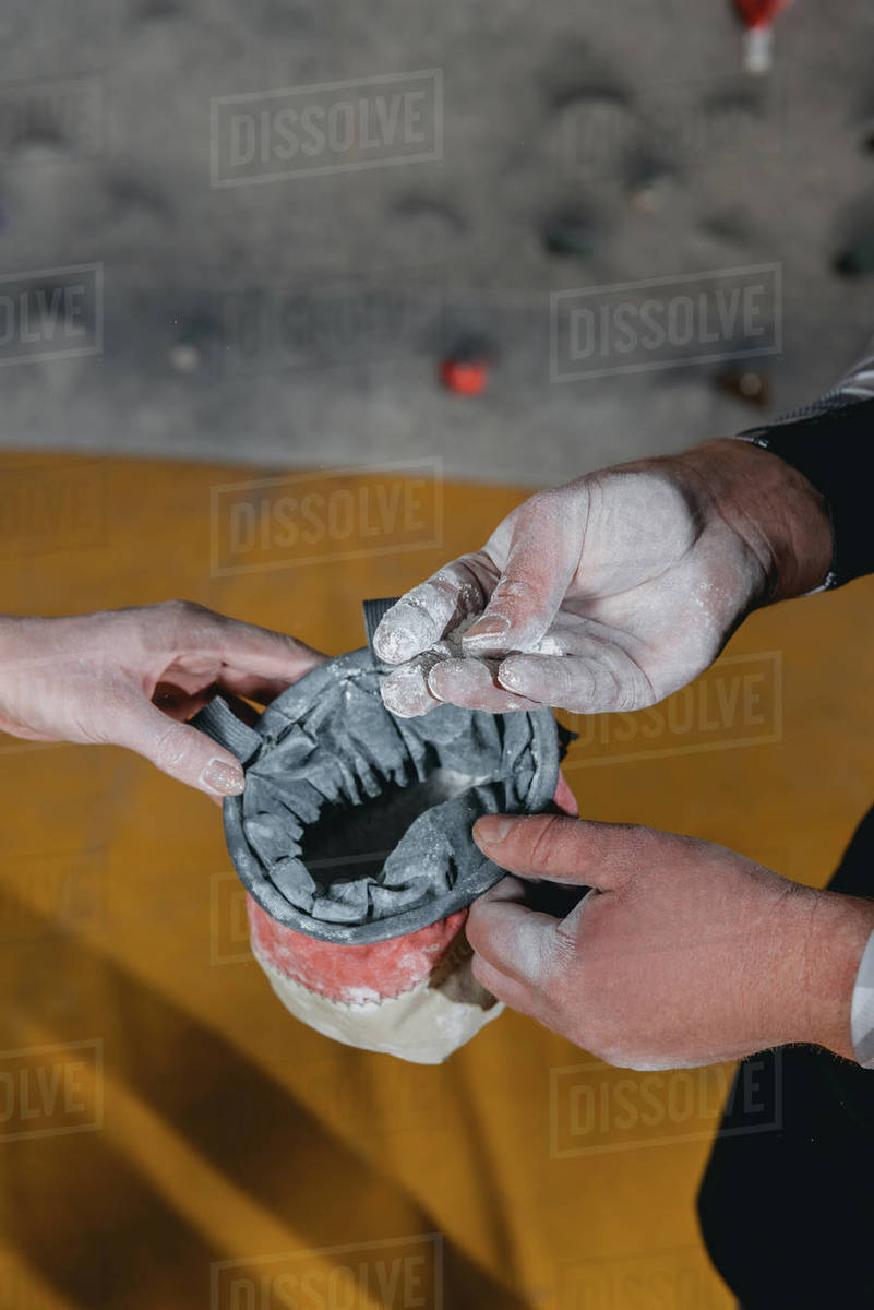 Closeup shot of man applying talcum powder to his hands from a bag ...
