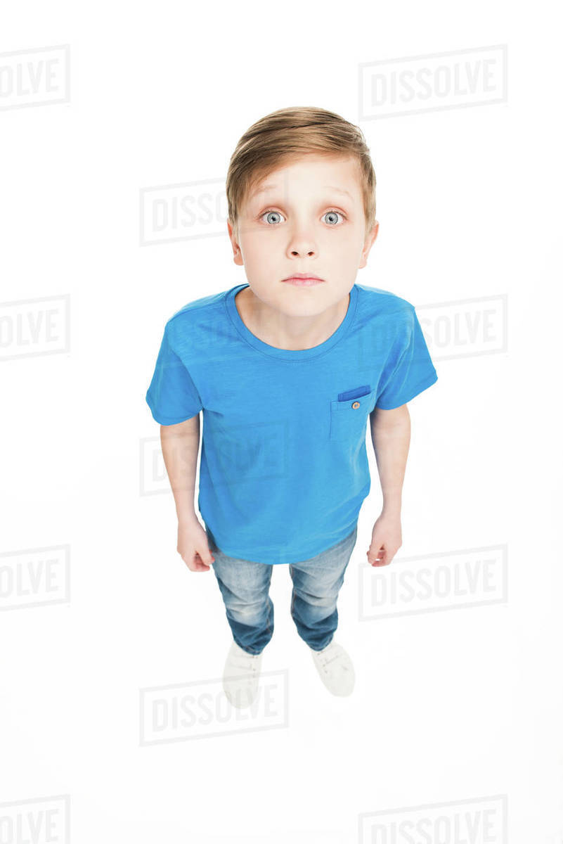 High angle view of cute little boy looking at camera isolated on white ...