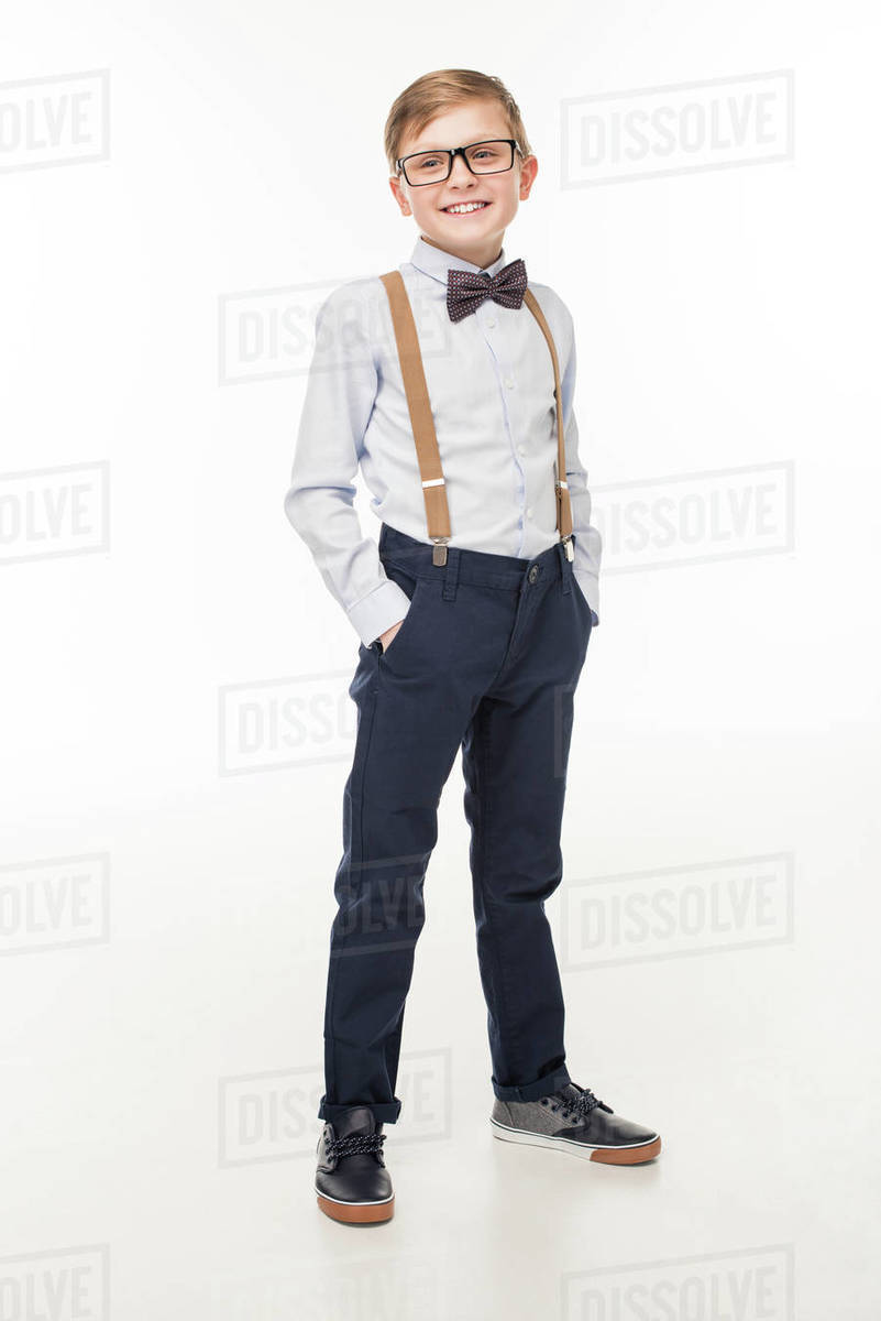 Full length view of happy stylish boy in eyeglasses standing with hands ...