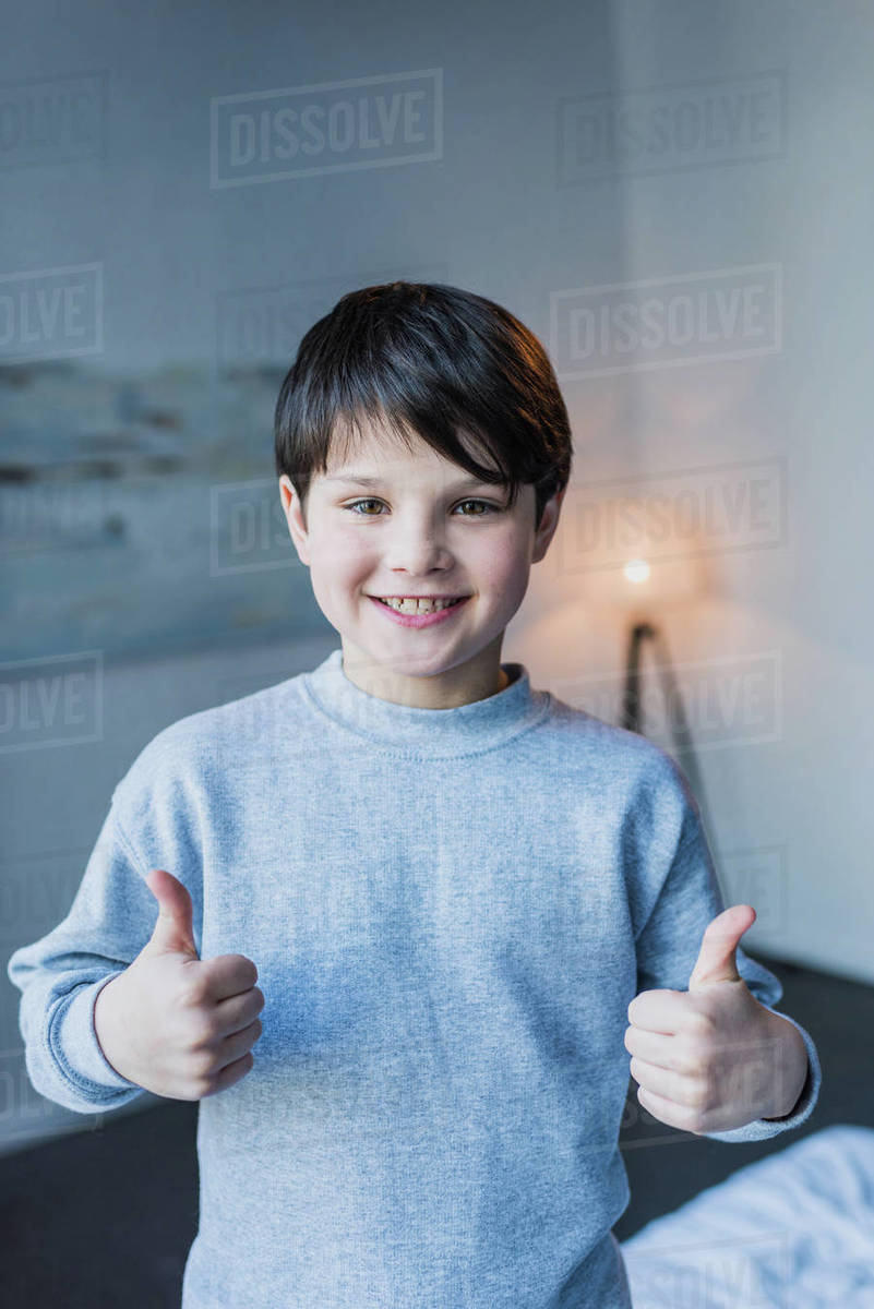 Cute little boy showing thumbs up and smiling at camera - Royalty-free ...