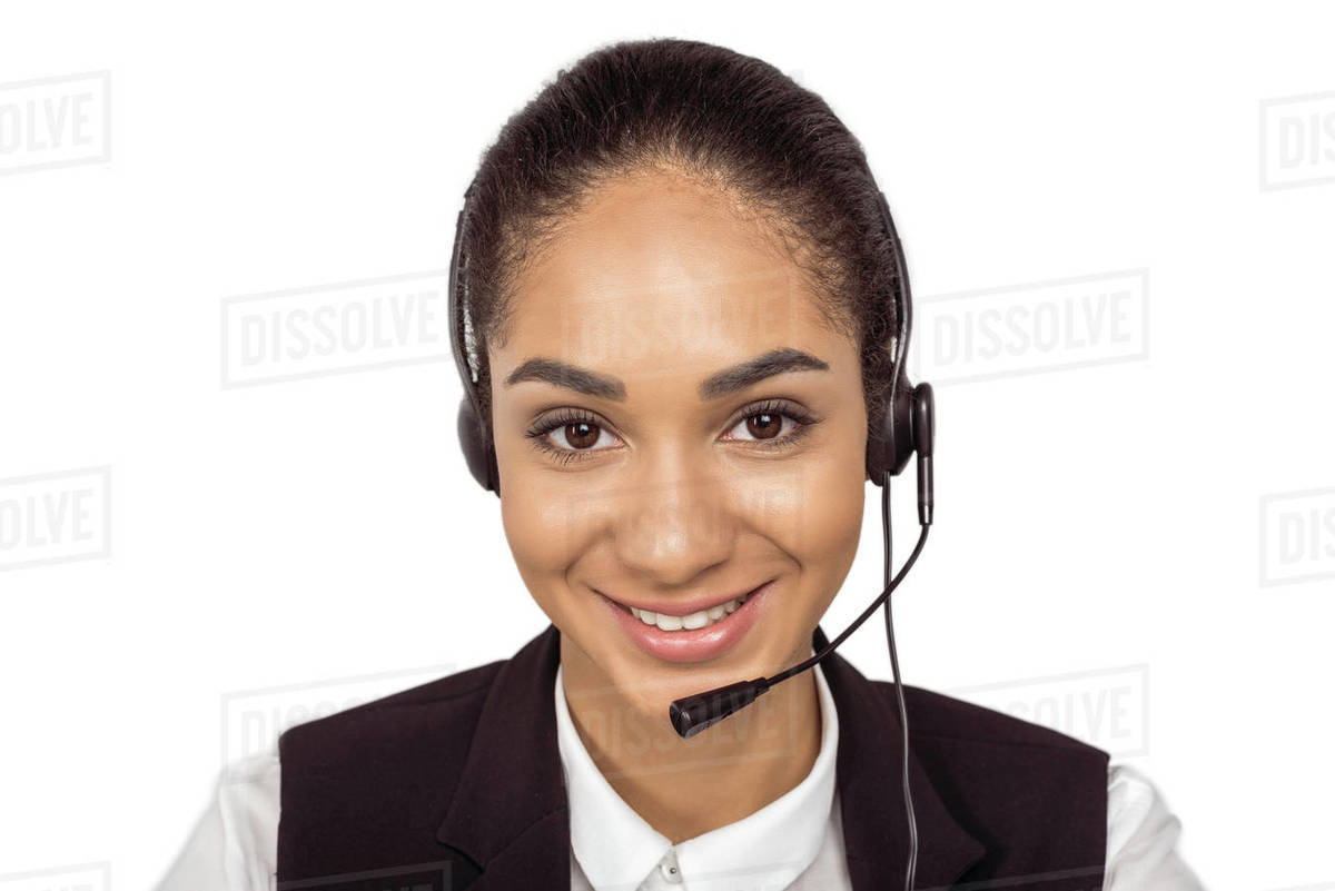Smiling young african american call center operator in headset looking at camera - Royalty-free ...