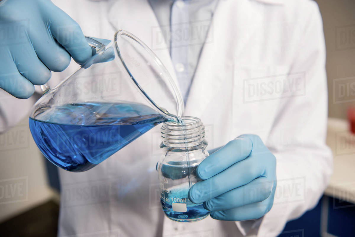 Partial view of professional scientist working with reagent in ...