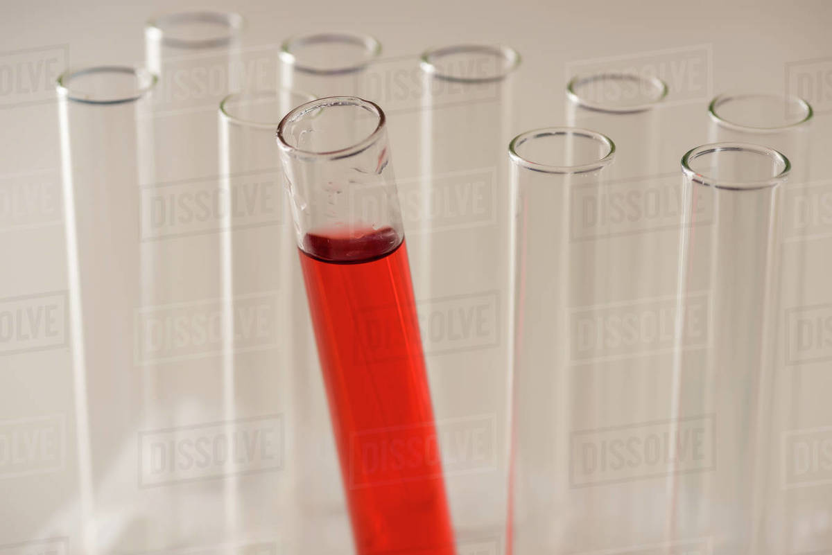 Close-up shot with row of long test tubes with red liquid - Royalty ...