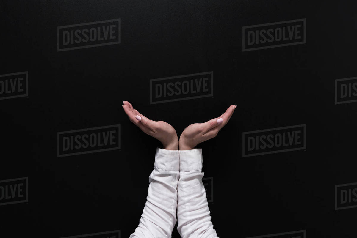 Cropped shot of woman showing with open hands isolated on black ...