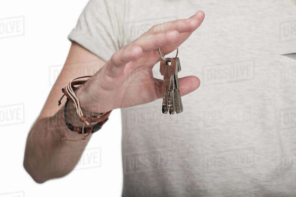 Cropped view of young man holding keys, isolated on white - Royalty ...