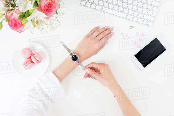 Top view of female hands with perfect manicure wearing wristwatch at ...