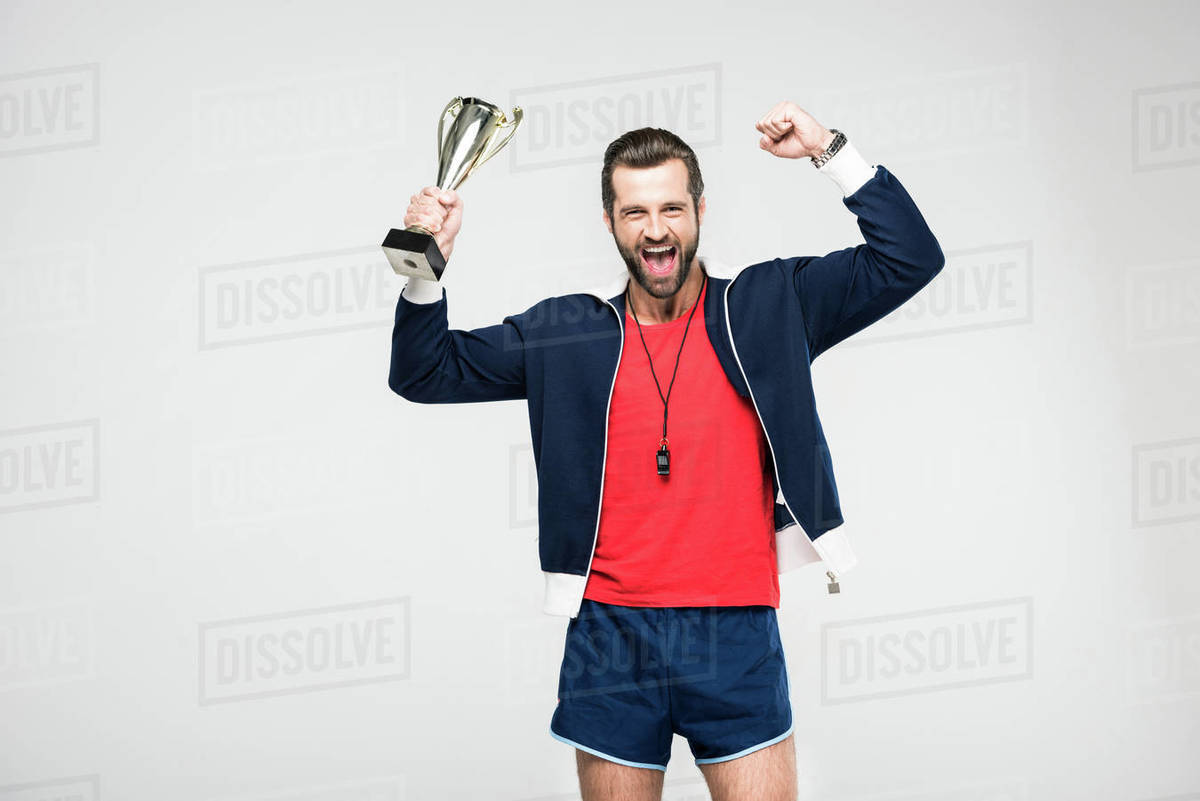 Excited sportive coach screaming and holding trophy cup, isolated on ...