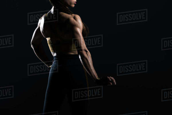 Female bodybuilder posing and showing muscles, isolated on black ...