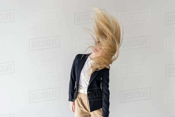 Beautiful stylish blonde girl shaking hair isolated on grey - Royalty ...