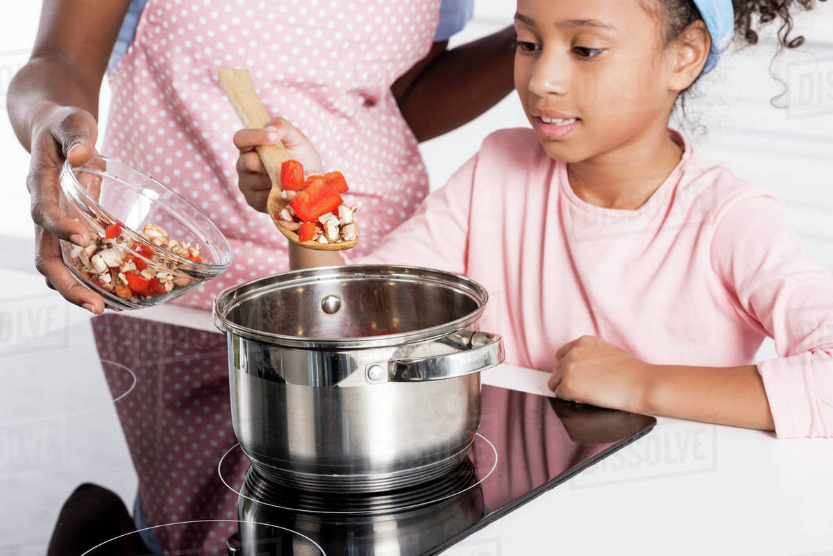 African american mother and daughter cooking on kitchen - Royalty-free ...