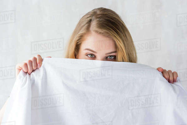 Beautiful blonde woman hiding by white sheets - Royalty-free Stock ...