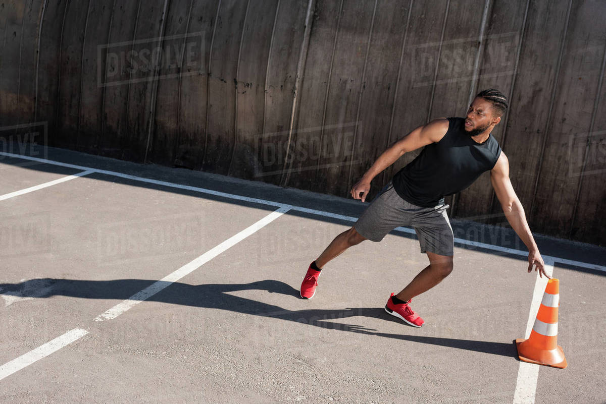 High angle view of young african american man running on street ...