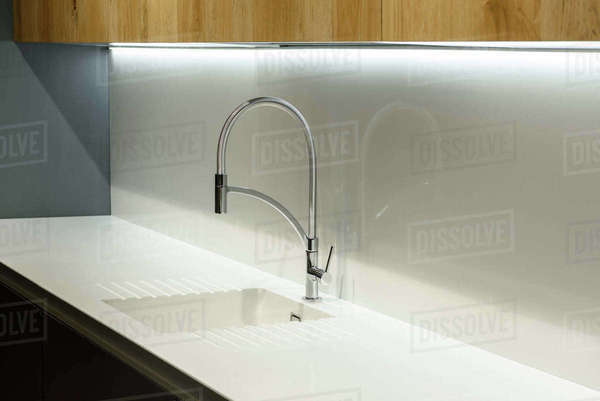 Close-up view of white sink in renovated kitchen - Royalty-free Stock ...