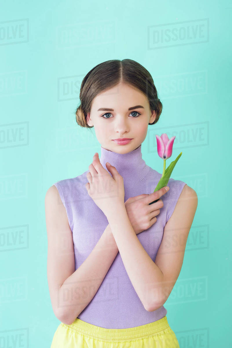 beautiful tender teenager posing with tulip flower, isolated on ...