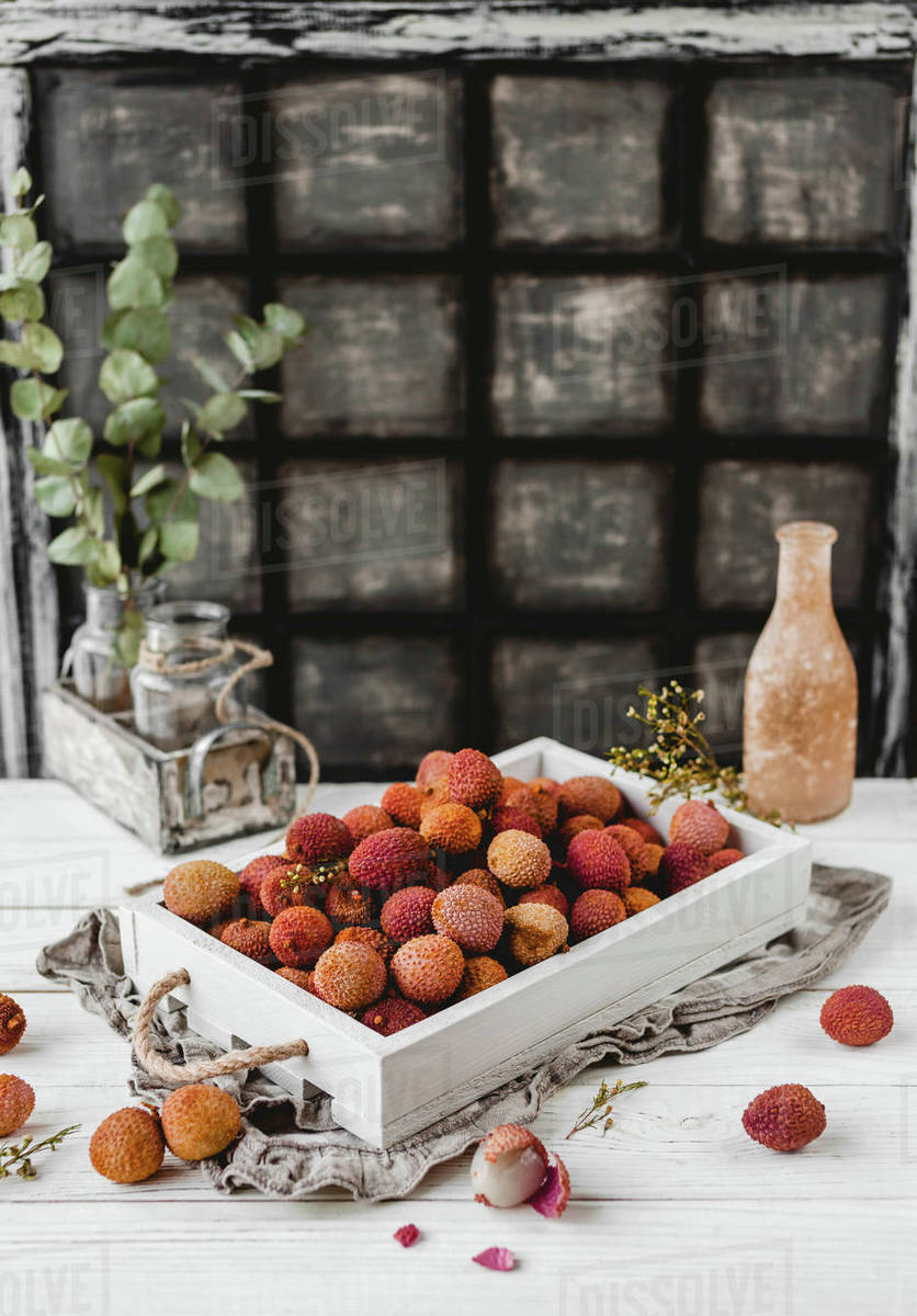 wooden box with lychees on white table - Royalty-free Stock Photo ...