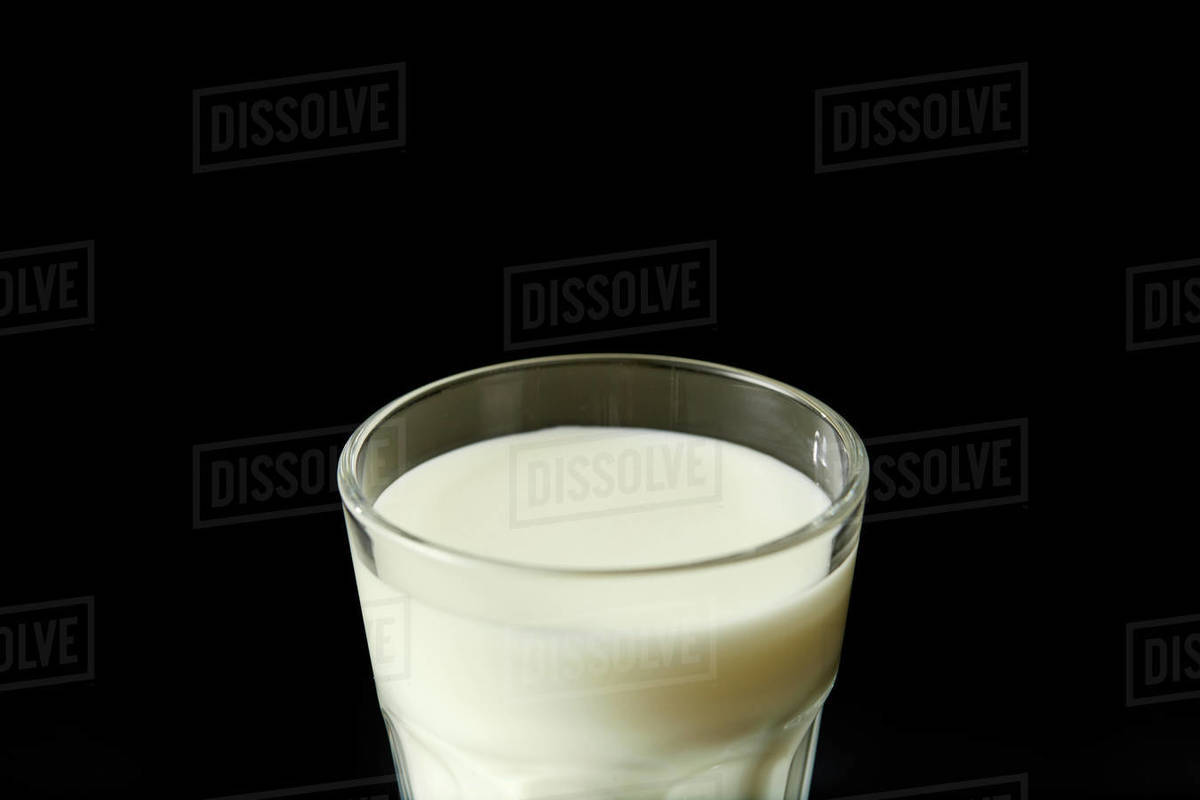 Close-up view of milk glass isolated on black background - Stock Photo ...